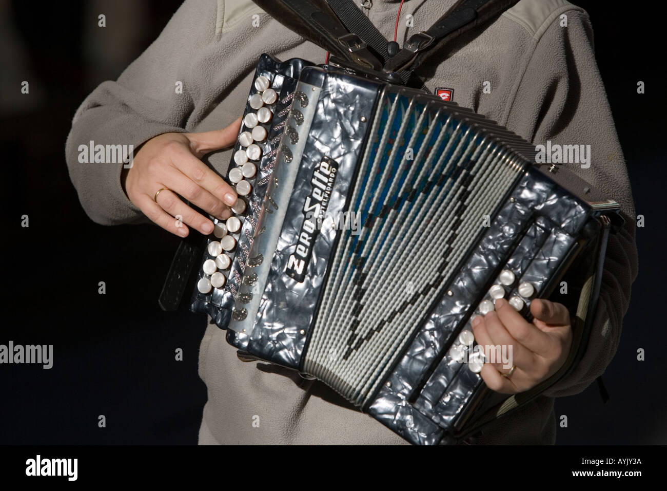 Close up of a Basque woman playing an accordion in the sunshine Casco ...