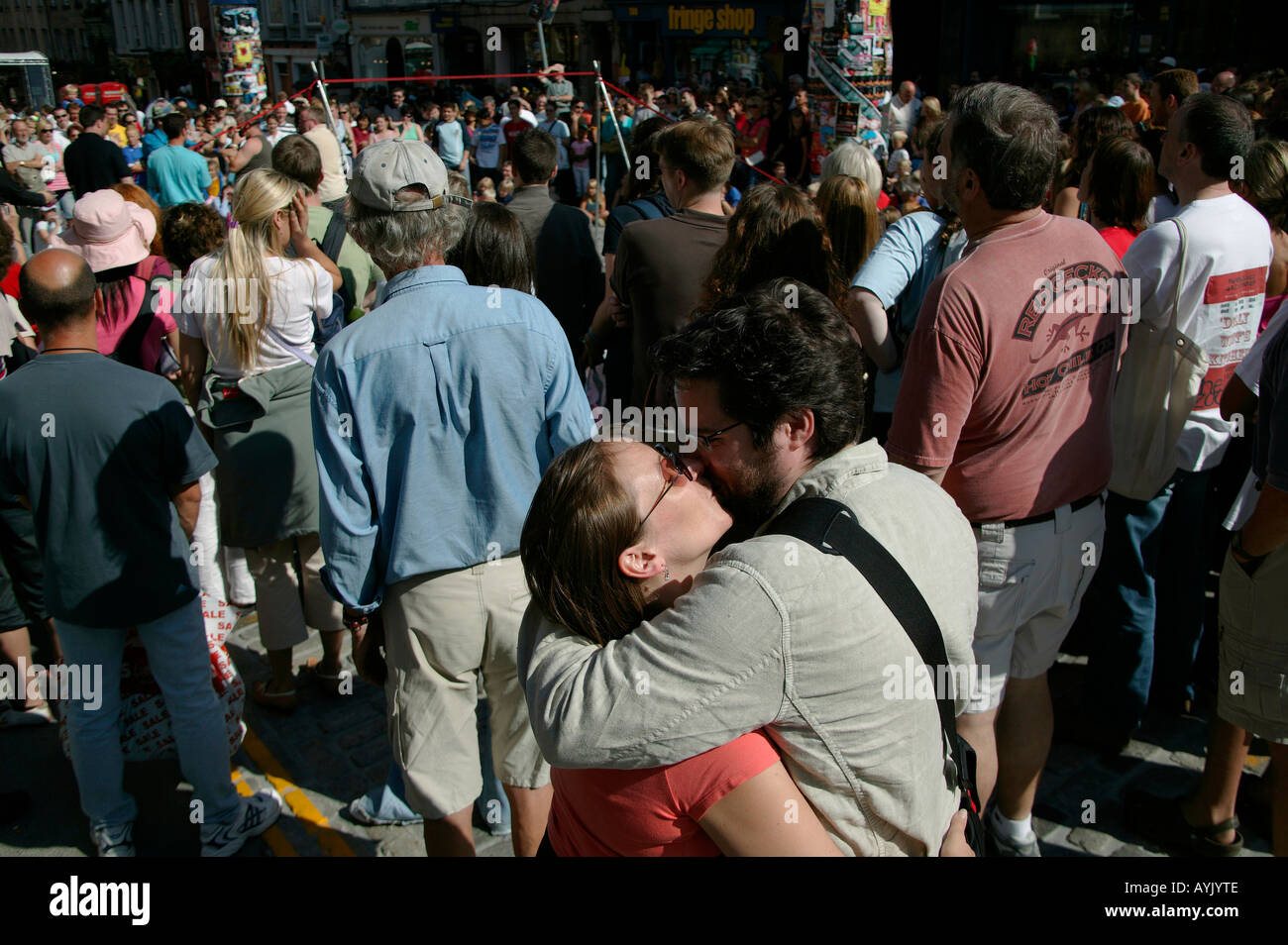 Young couple kissing in street, Edinburgh Fringe Festival, Scotland ...