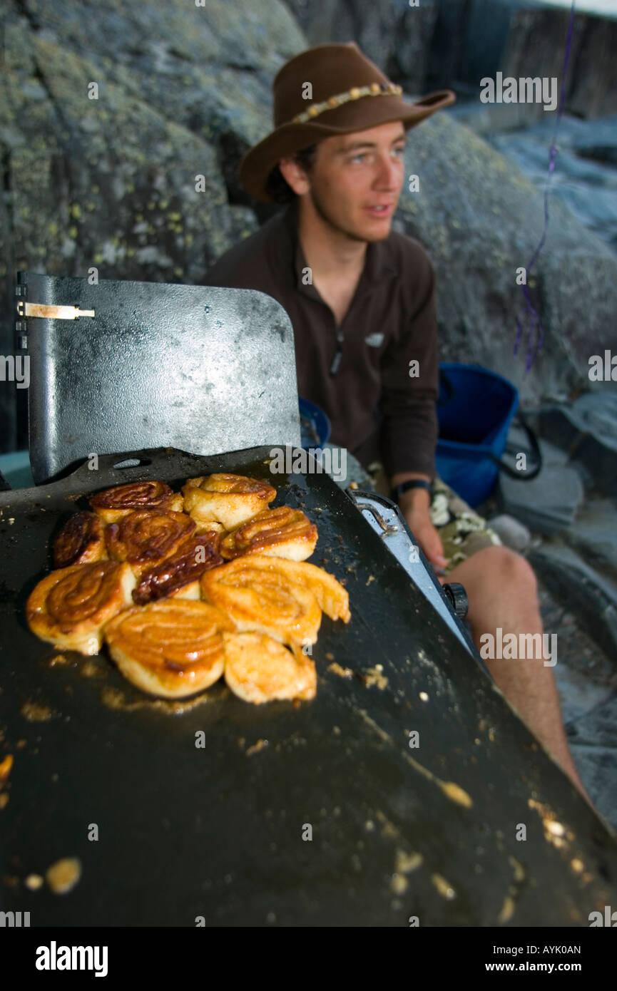 Paddling guide with cinnamon buns around campsite Stock Photo - Alamy