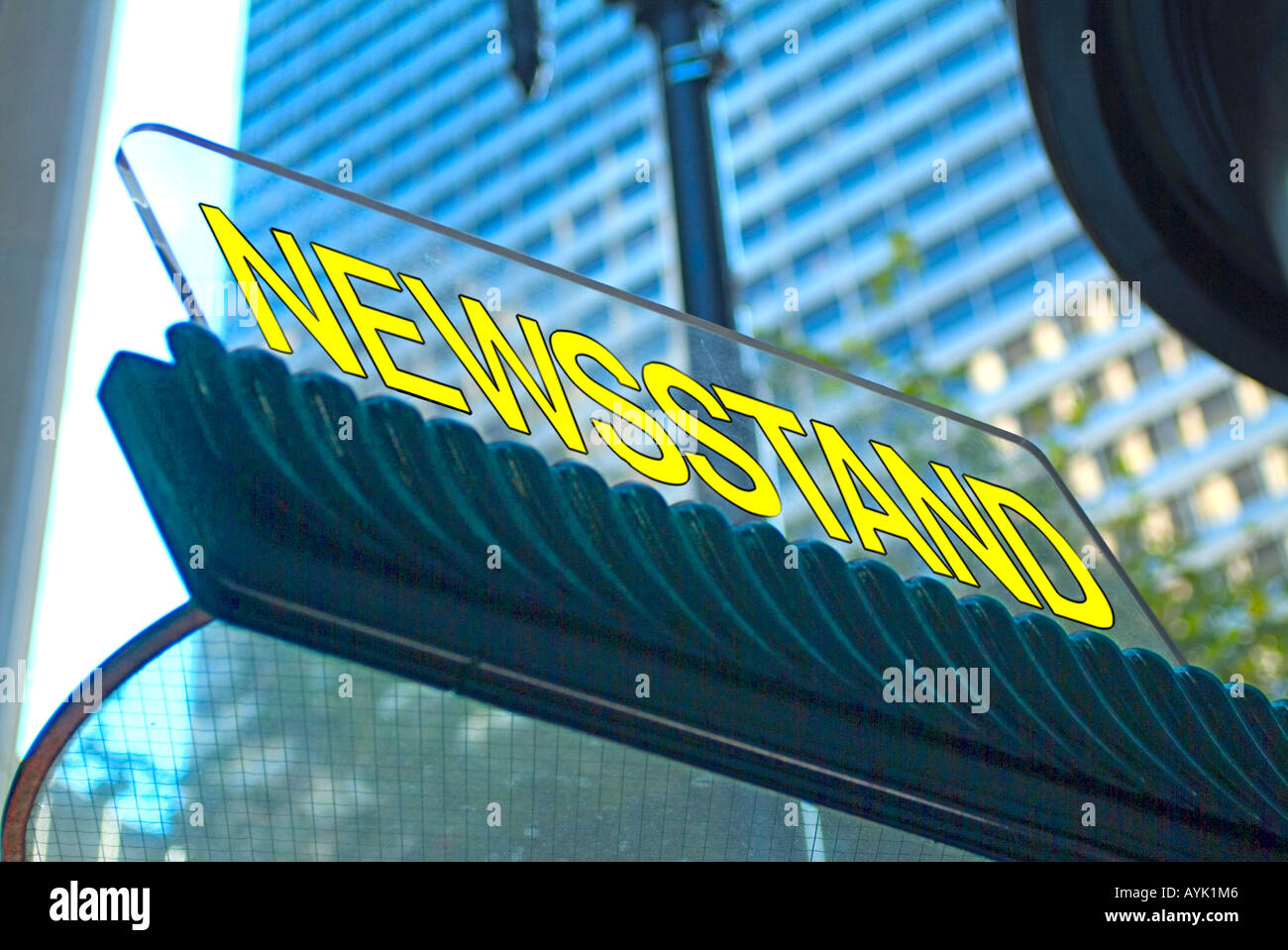 Clear News Stand Sign with bright yellow lettering on a city street in ...