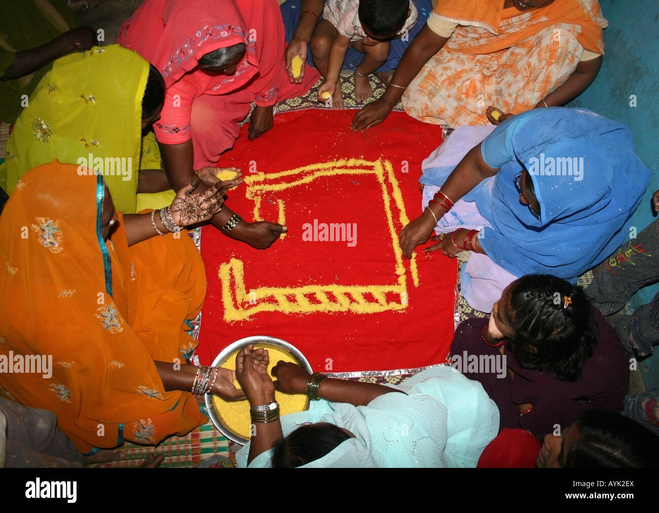 Muslim women make rice patterns for the muslim groom in a ceremony ...