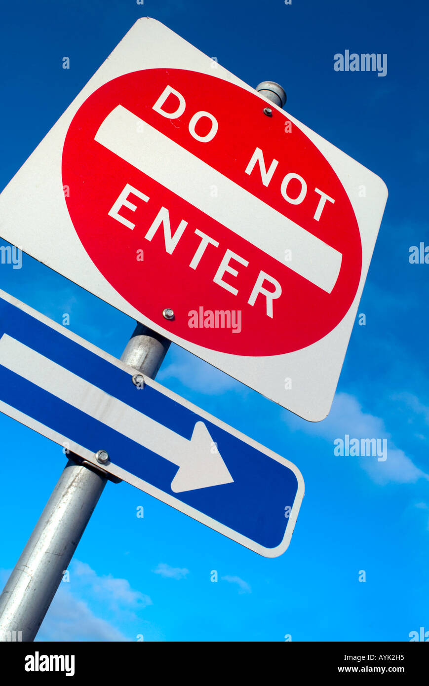 Do not enter traffic sign with arrow sign below with blue sky ...