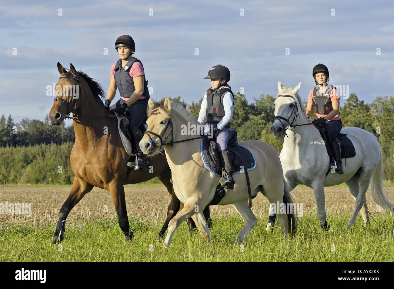 three girls riding Stock Photo - Alamy