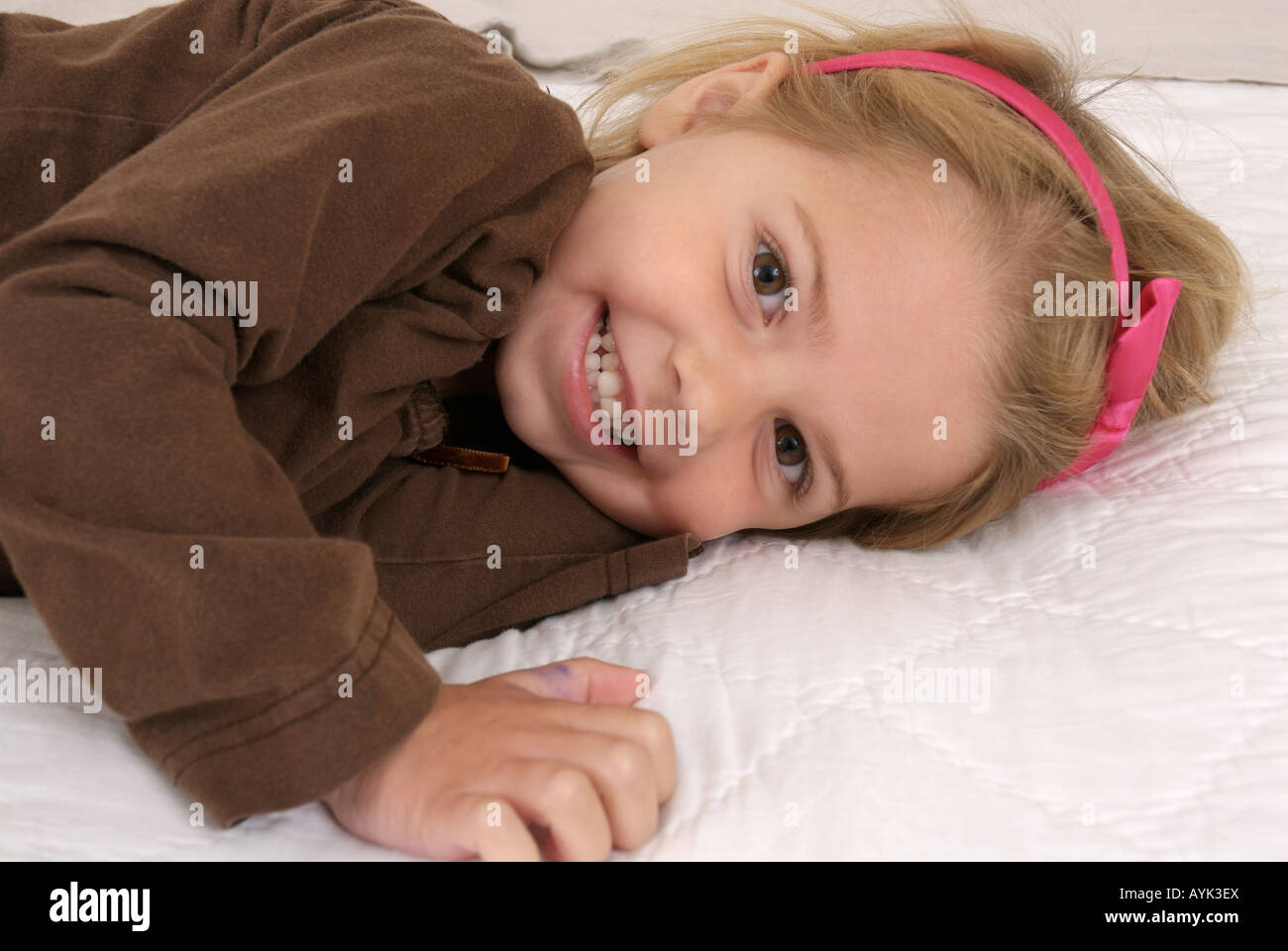Portrait of a smiling cheeky little girl Stock Photo - Alamy