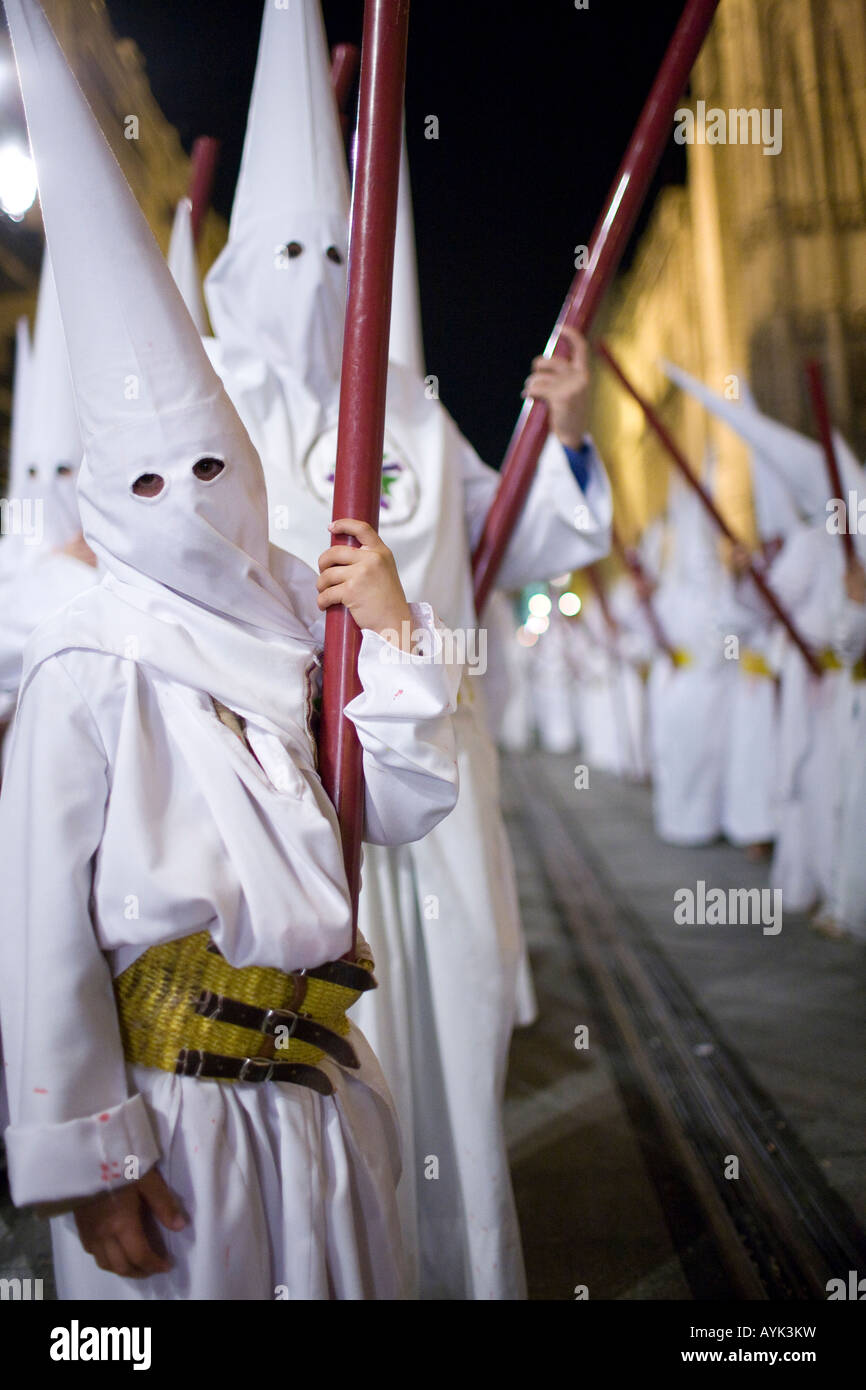 Young penitents bearing candles, Holy Week, Seville, Spain Stock Photo ...