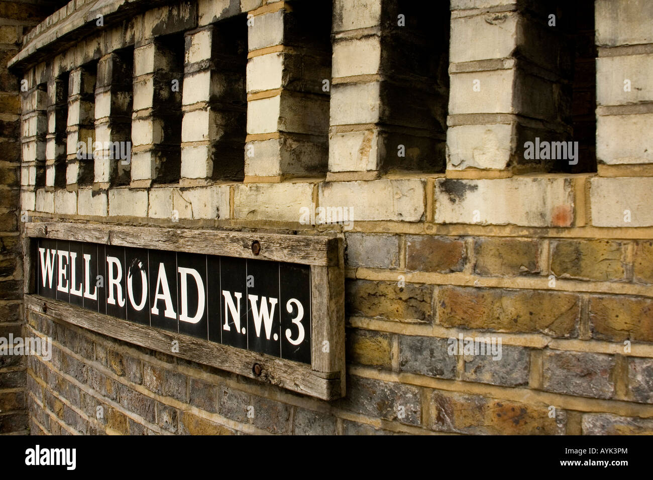Old historic tiled street sign on brick wall in wooden frame Hampstead ...