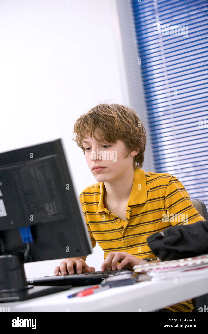 Teenage boy behind a computer Stock Photo - Alamy