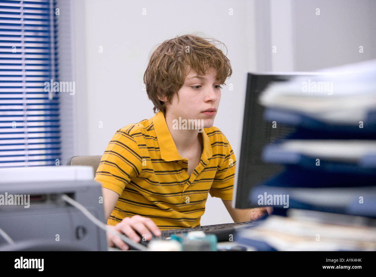 Teenage boy behind a computer Stock Photo - Alamy