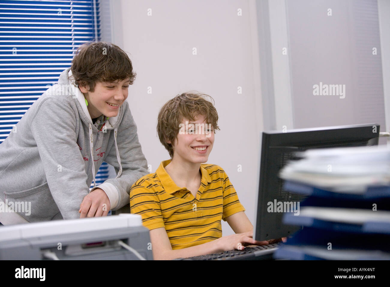 Two teenage boys behind a computer Stock Photo - Alamy