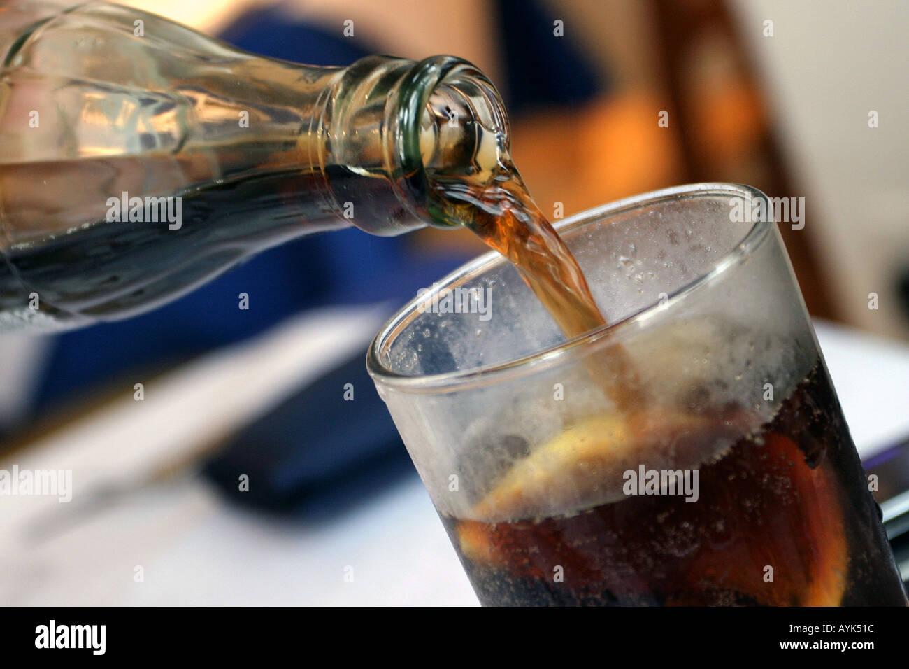 Bottle of coke being poured into chilled glass Stock Photo - Alamy