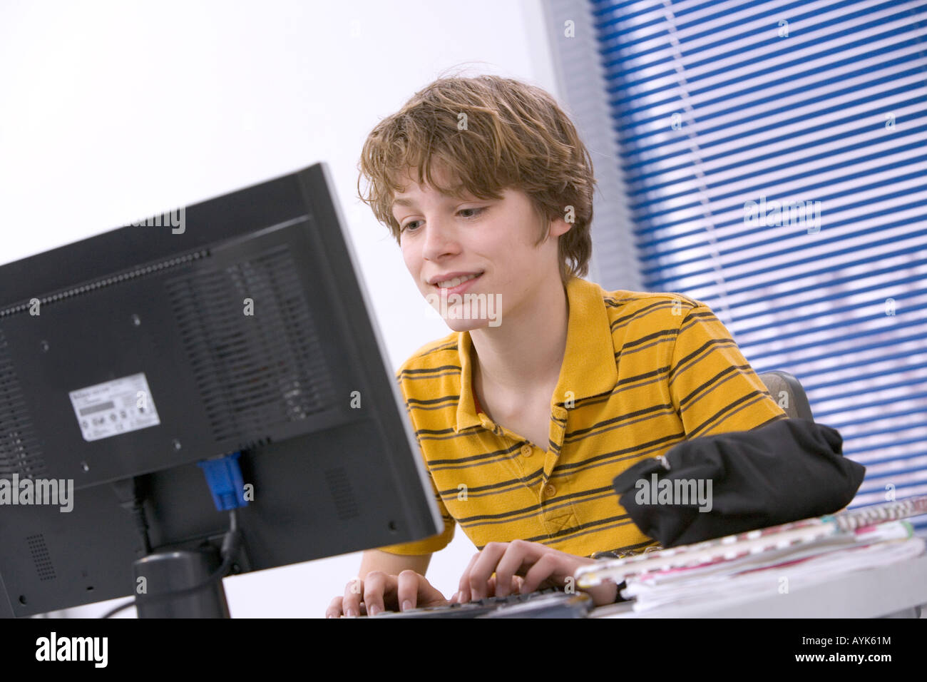 Teenage boy behind a computer Stock Photo - Alamy
