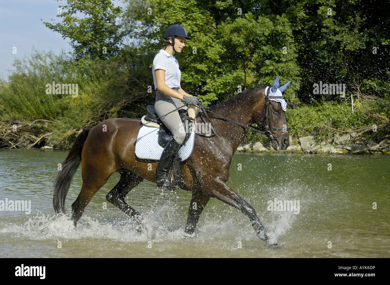 girl riding through a river Stock Photo - Alamy