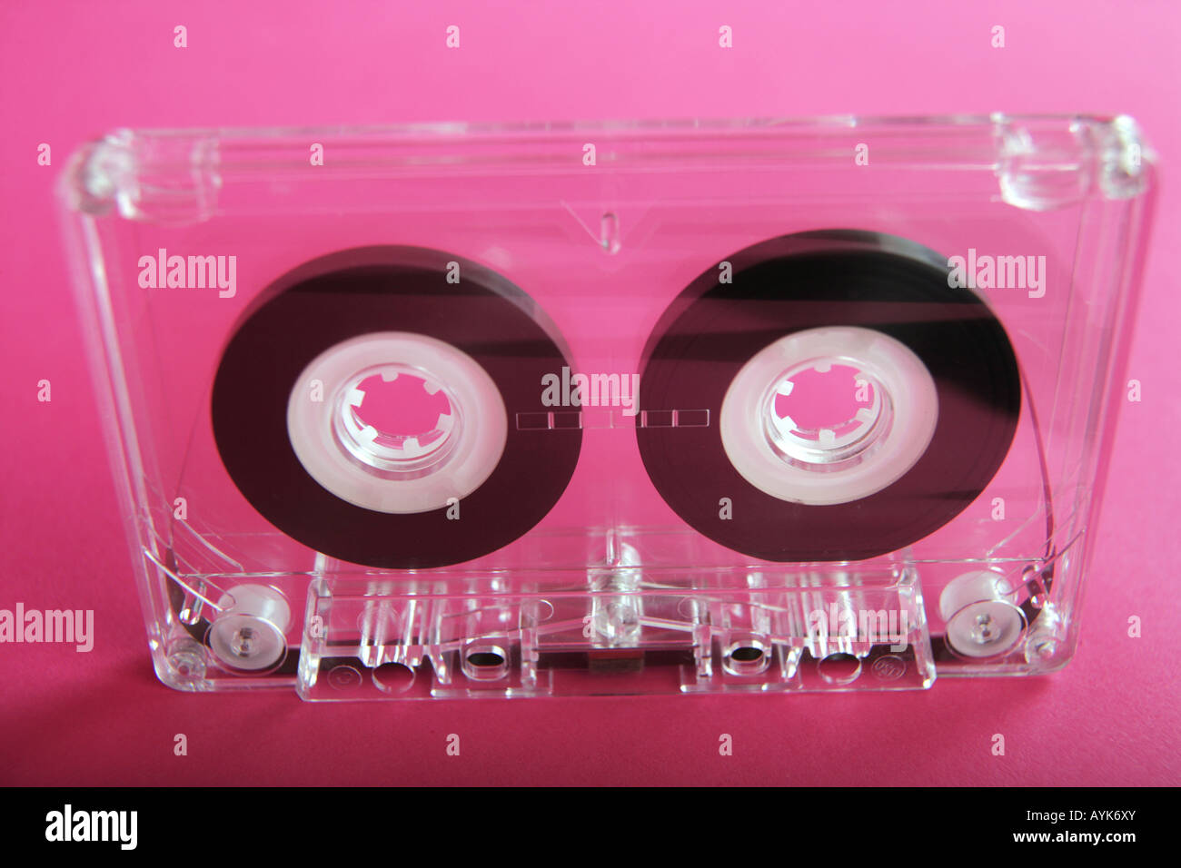 Transparent Audio Cassette tape on a pink background Stock Photo - Alamy