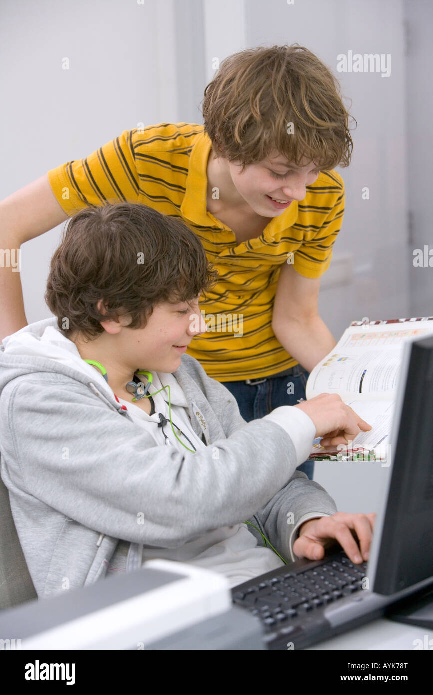 Two teenage boys behind a computer Stock Photo - Alamy