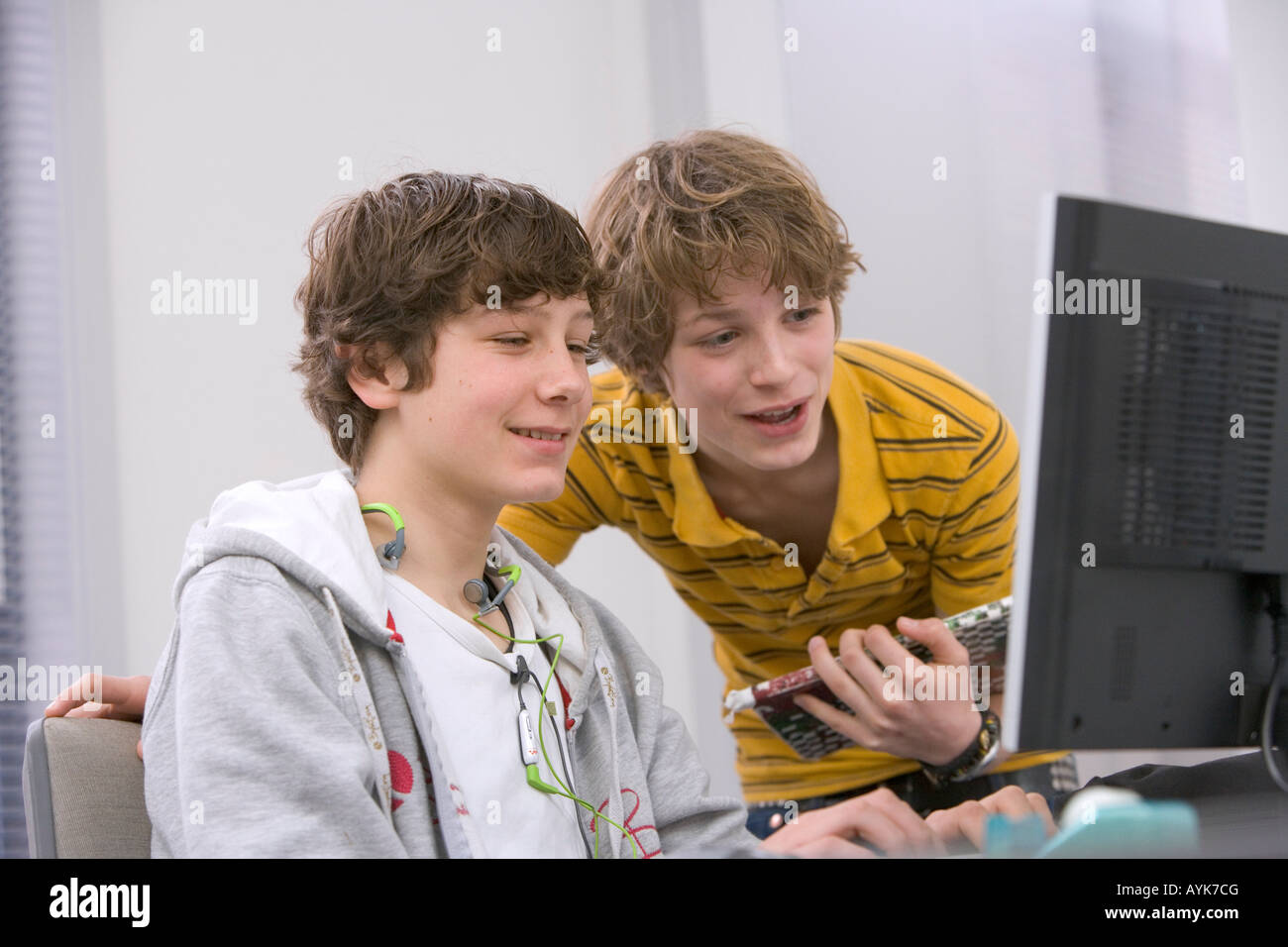 Two teenage boys behind a computer Stock Photo - Alamy