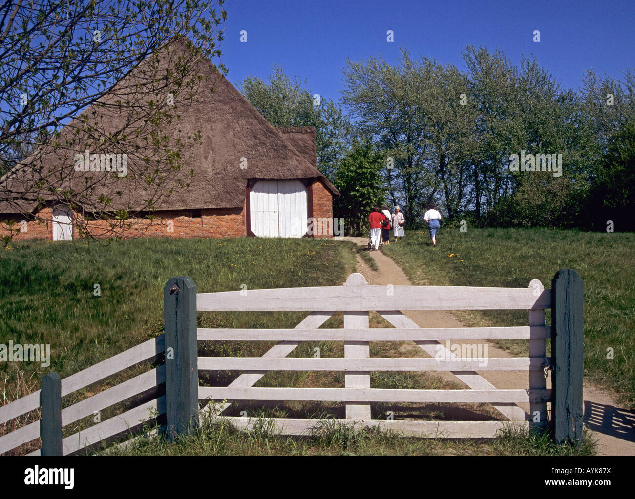 tourists visiting a 19th century Danish farm in Friland countryman ...