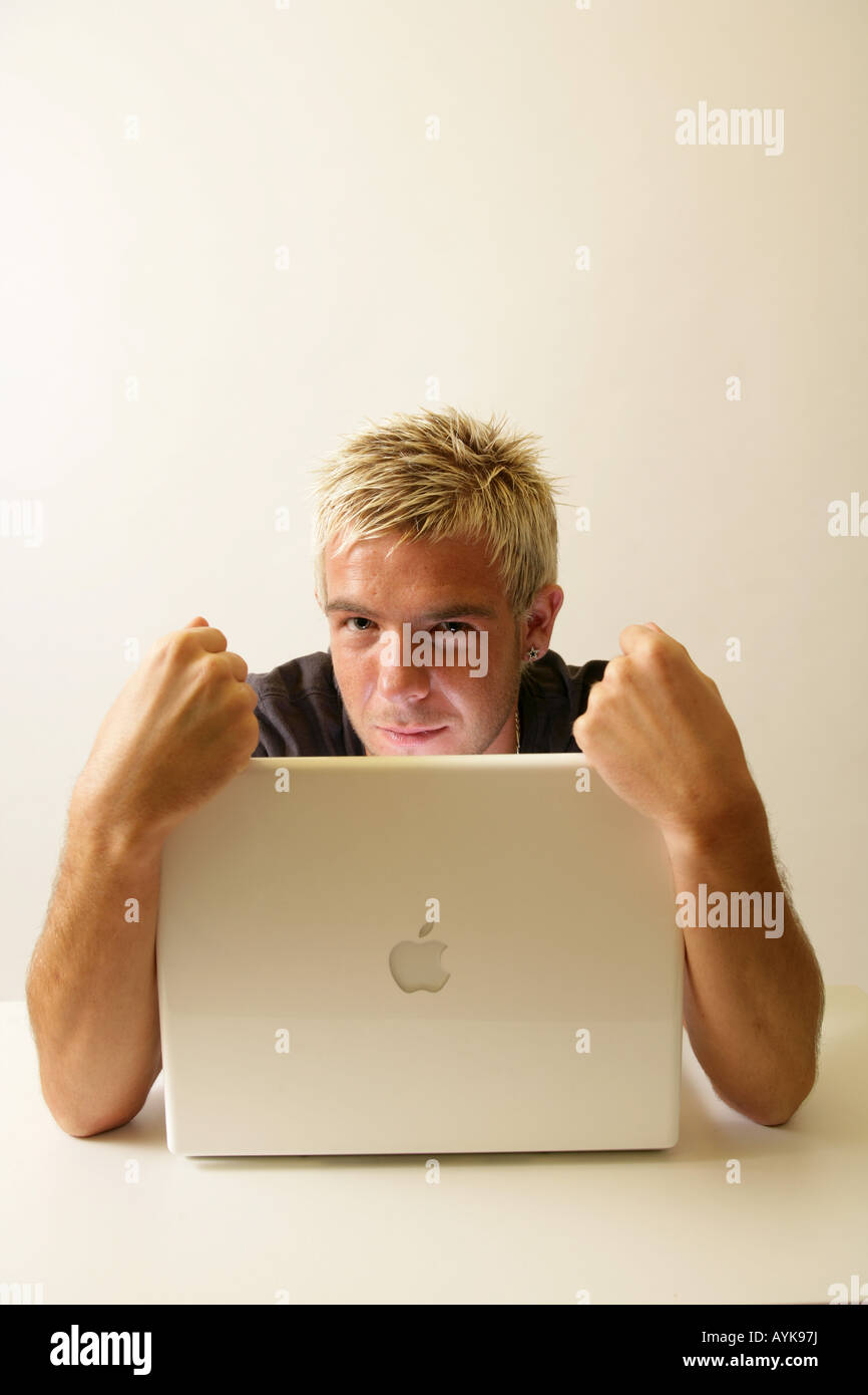 man holding onto a apple mac laptop Stock Photo - Alamy