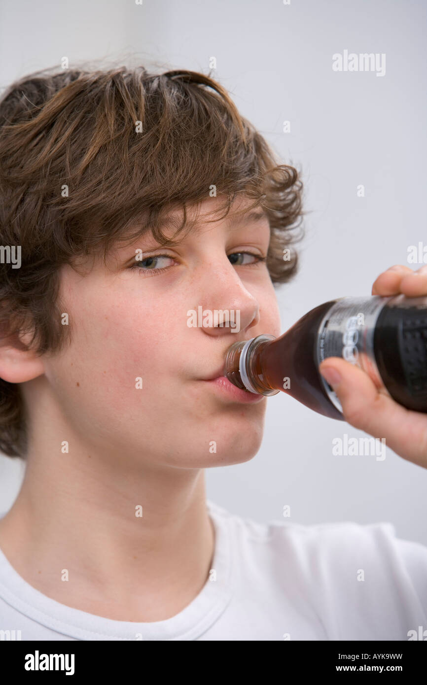 Teenage boy drinking soft drink Stock Photo - Alamy