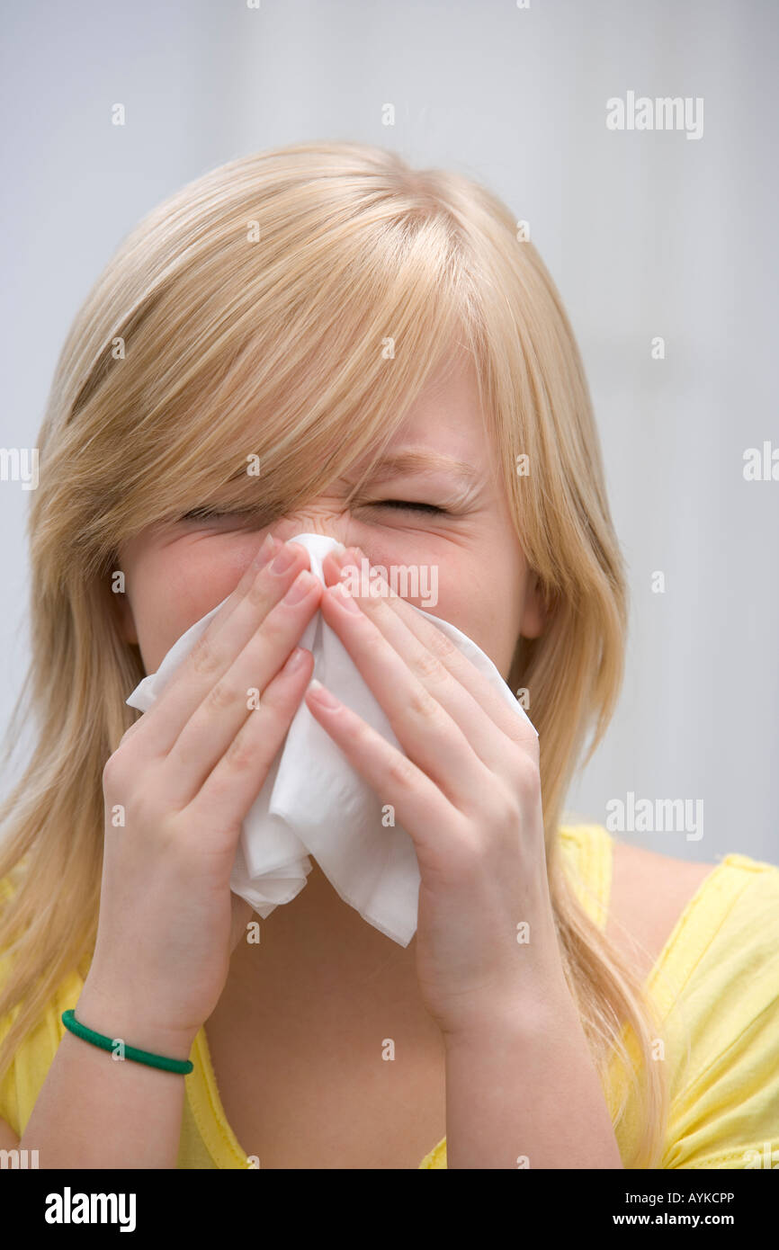 Teenage girl sneezing Stock Photo - Alamy