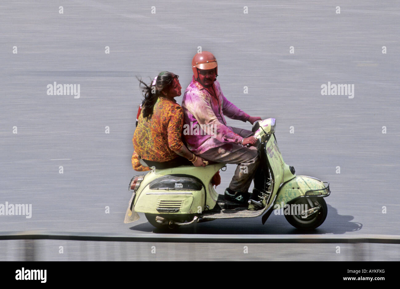 A color smeared couple on a Vespa during the Rangwali Holi festival ...