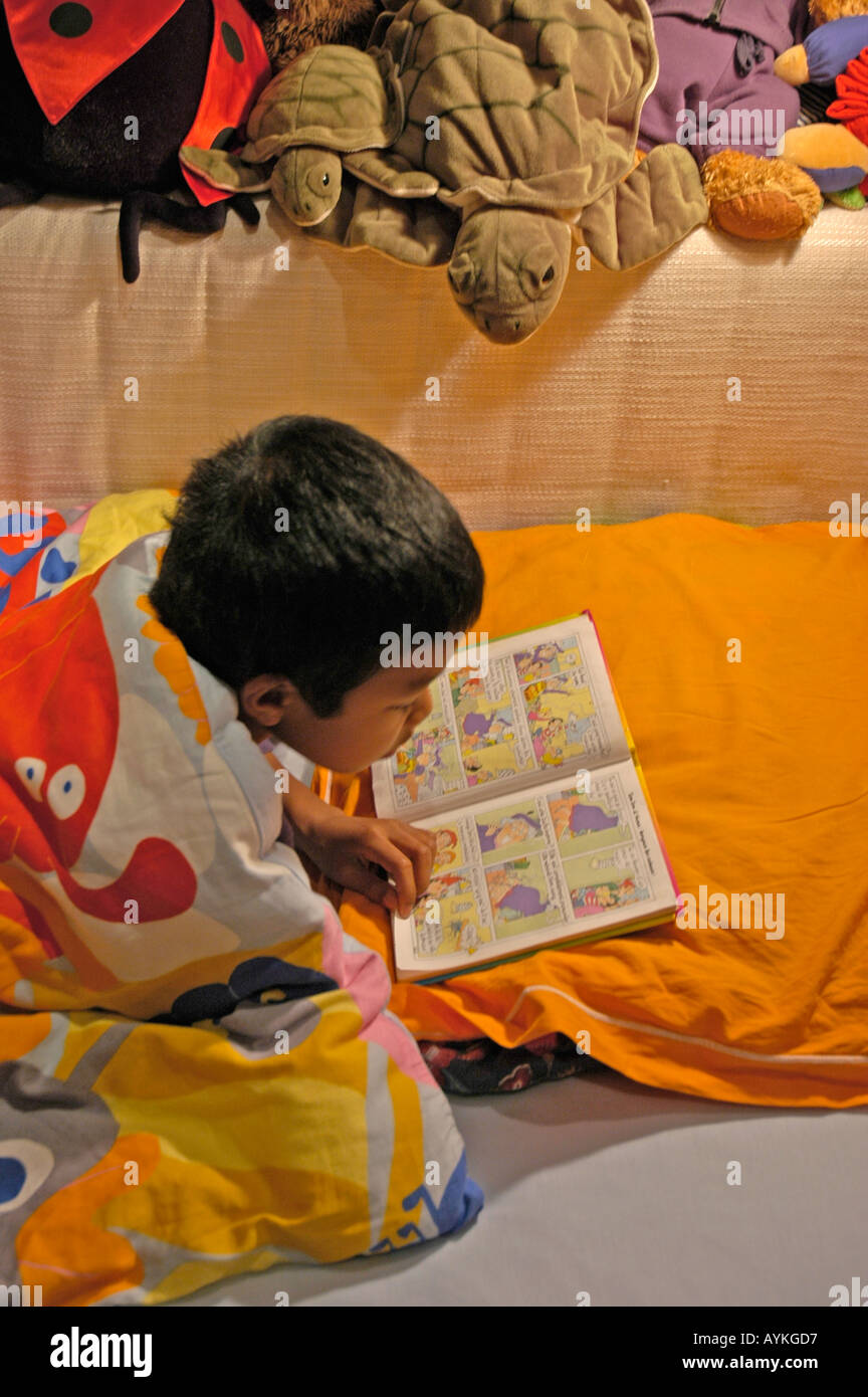 boy reading a comic in the bed Stock Photo - Alamy