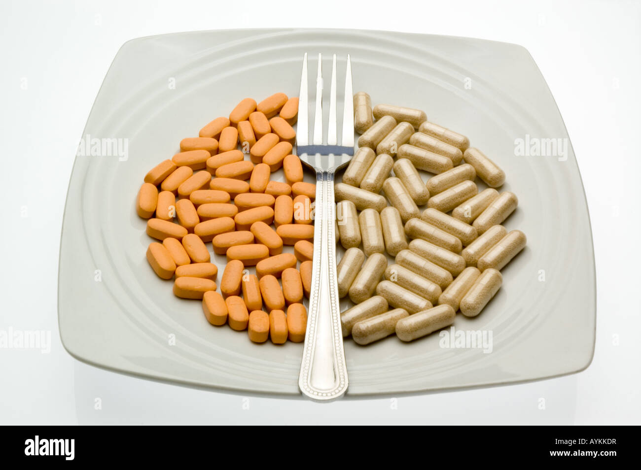 Dinner plate filled with mix of pills and capsules Stock Photo - Alamy