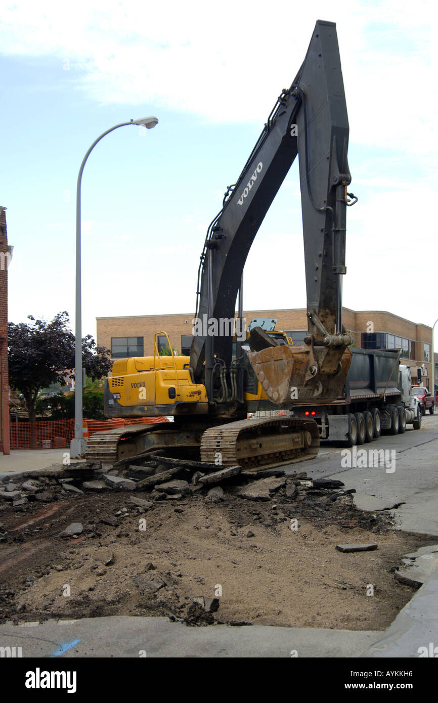 An excavator ripping up the road surface Stock Photo - Alamy