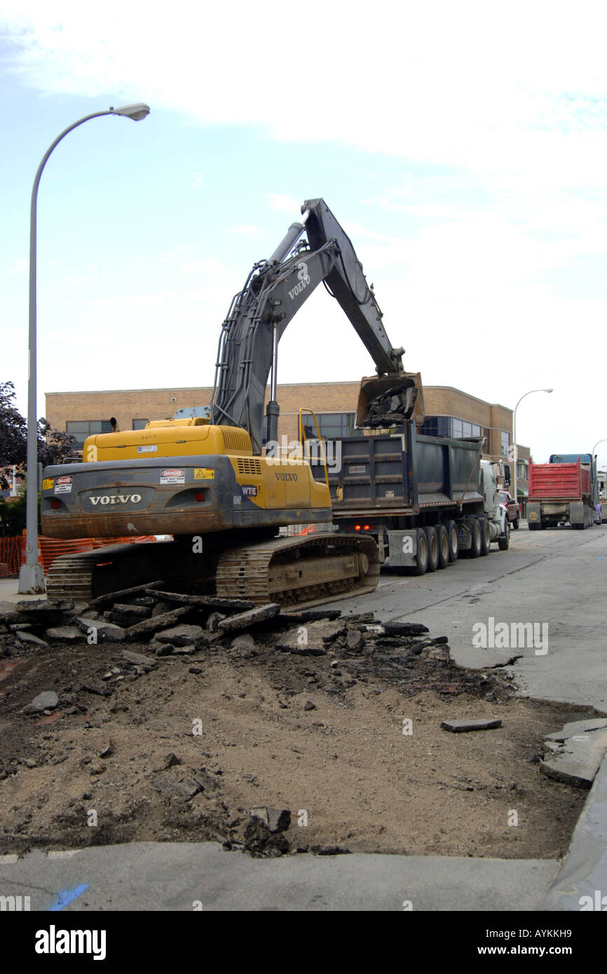 An excavator ripping up the road surface Stock Photo - Alamy