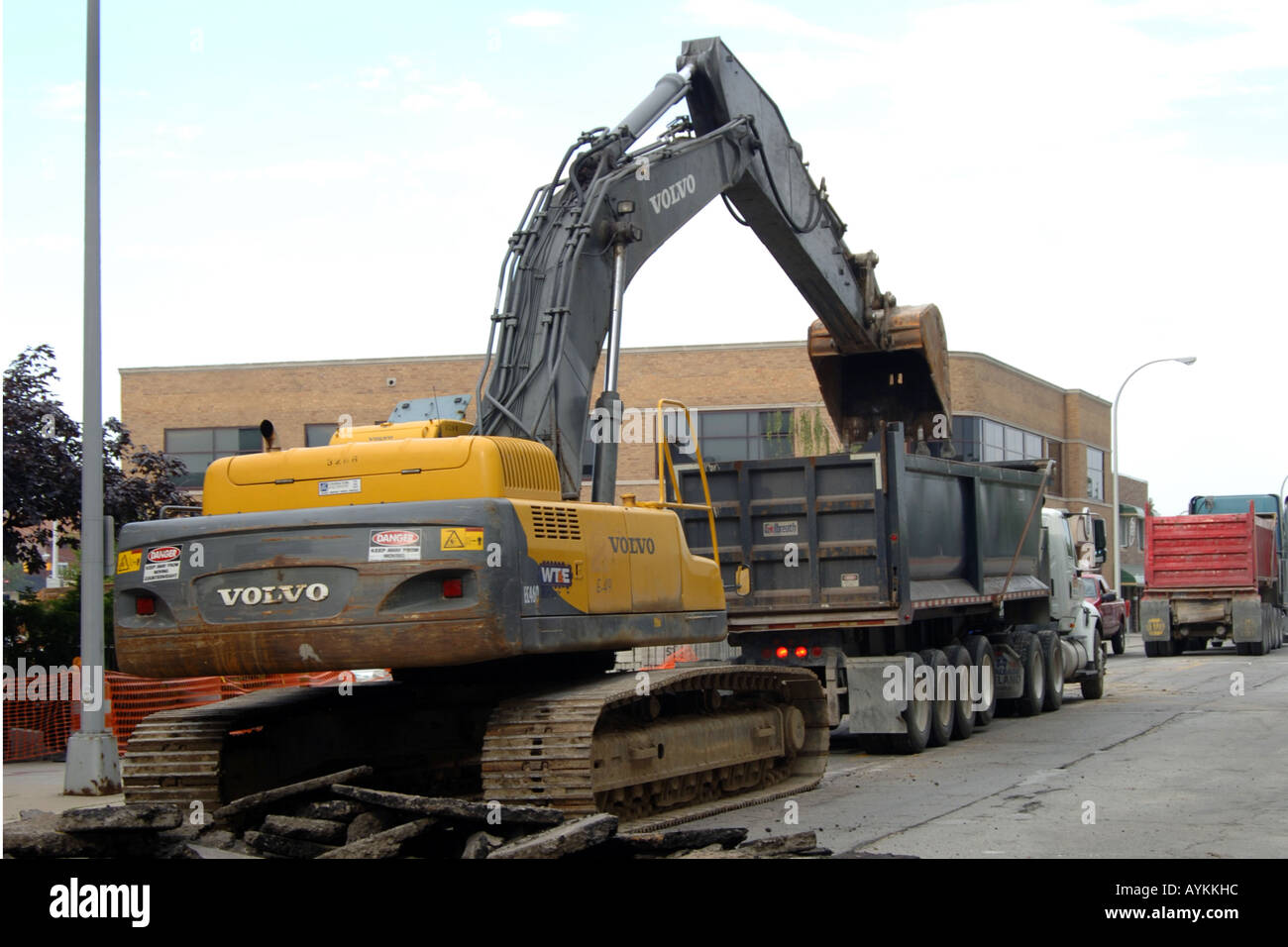 An excavator ripping up the road surface Stock Photo - Alamy