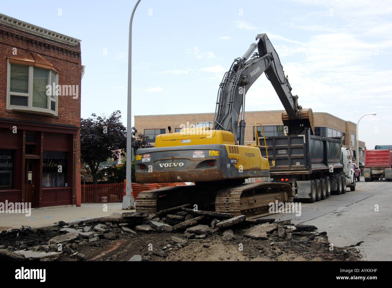 An excavator ripping up the road surface Stock Photo - Alamy