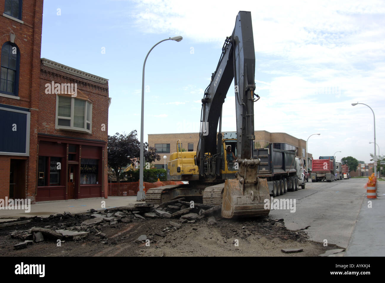 An excavator ripping up the road surface Stock Photo - Alamy