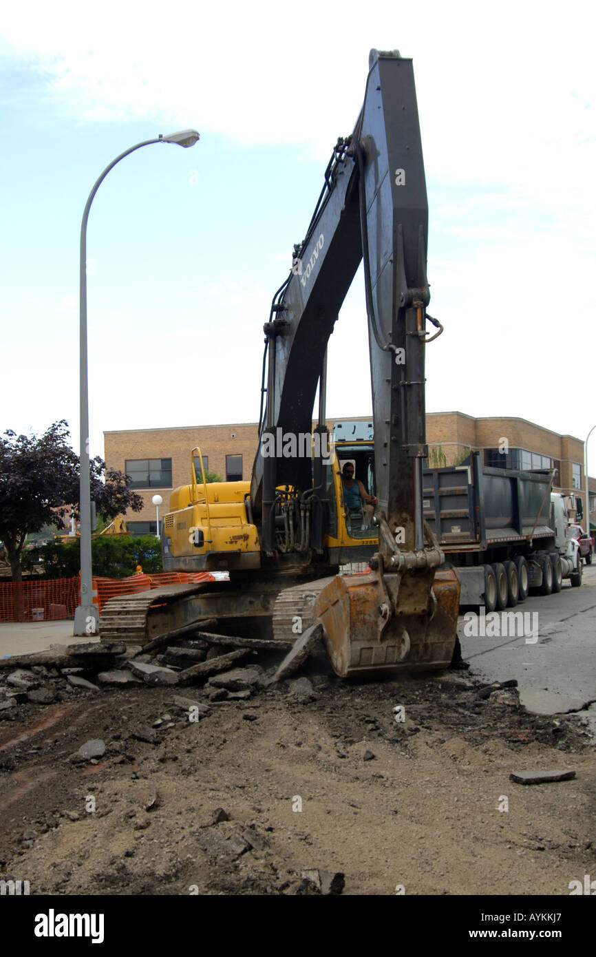 An excavator ripping up the road surface Stock Photo - Alamy