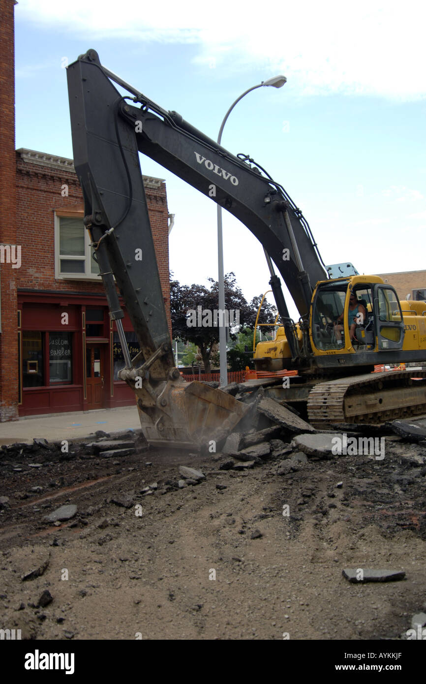 An excavator ripping up the road surface Stock Photo - Alamy
