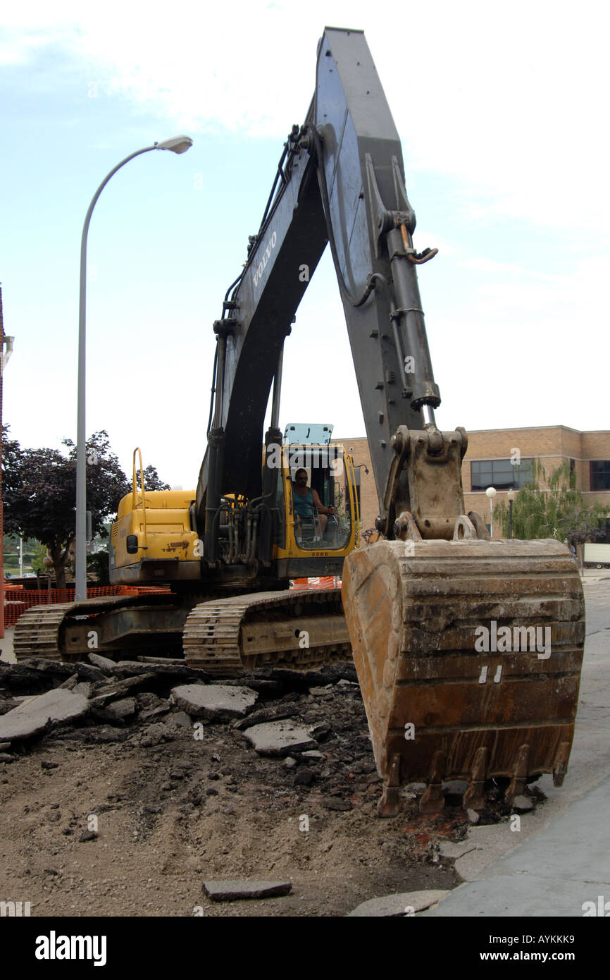 An excavator ripping up the road surface Stock Photo - Alamy