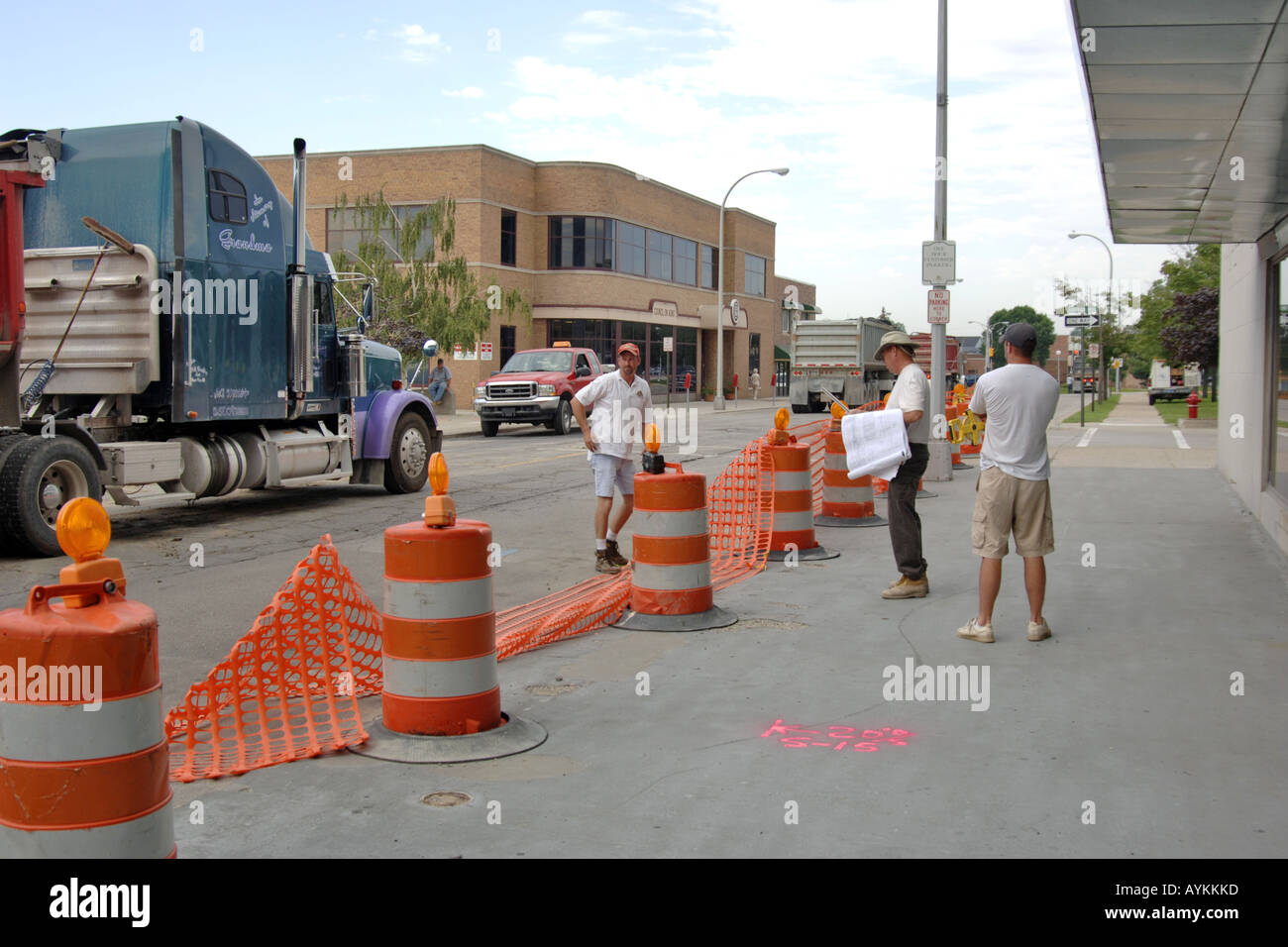 Roadway maintenance workers setting out traffic cones and fencing Stock ...