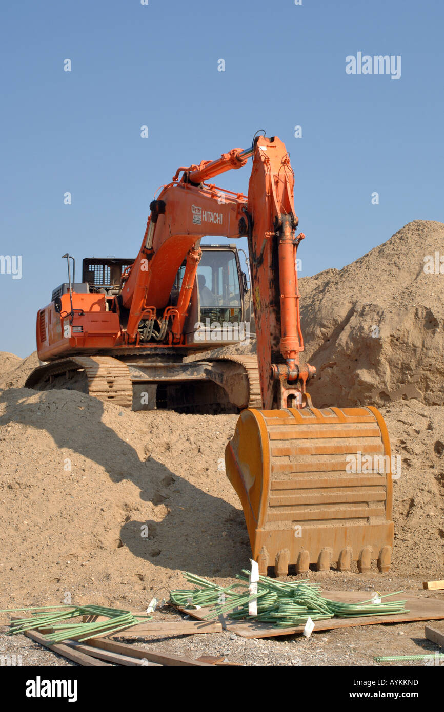 Bright orange colored backhoe excavator machine on a construction site ...
