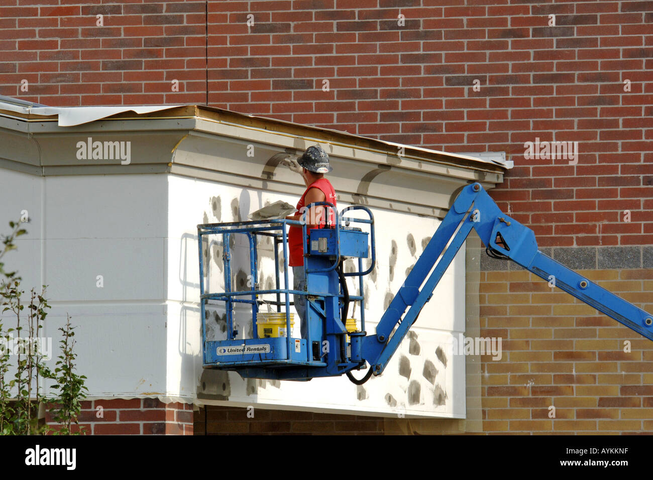 Construction worker using a Cherry Picker machine to reach a job ...