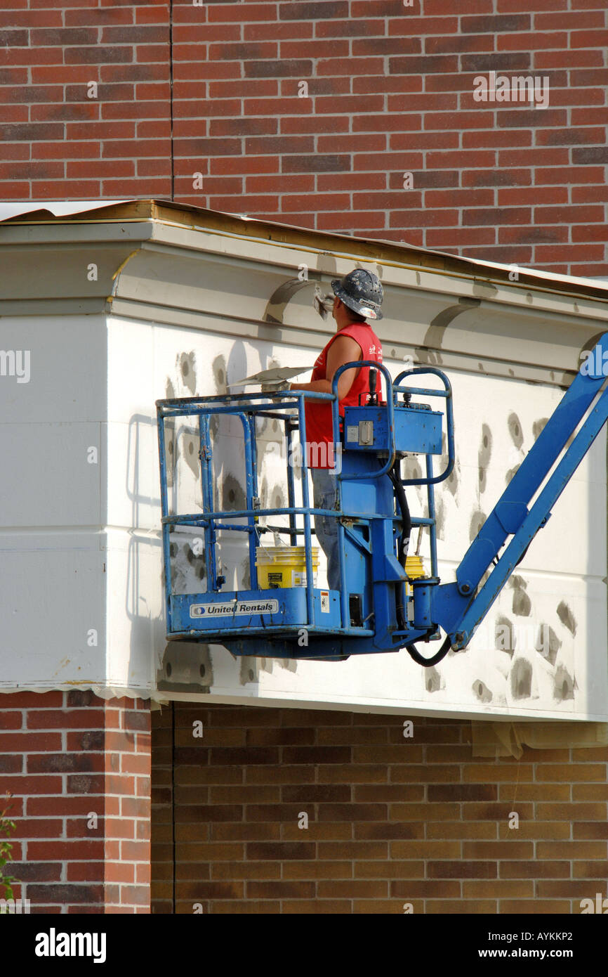 Construction worker using a Cherry Picker machine to reach a job ...