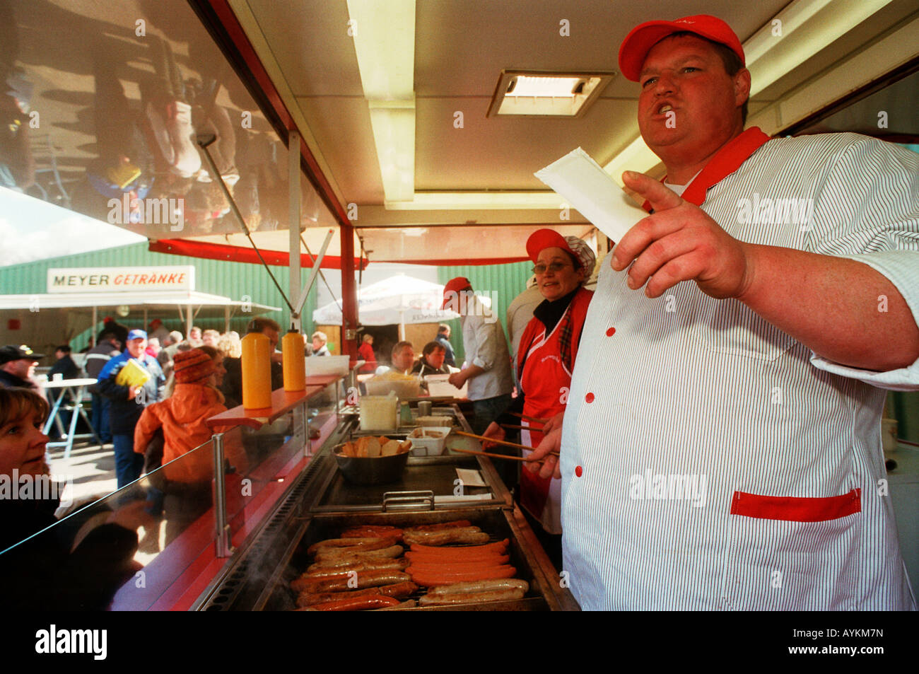 Corpulent man taking orders in a takeaway, Quellen, Germany Stock Photo ...