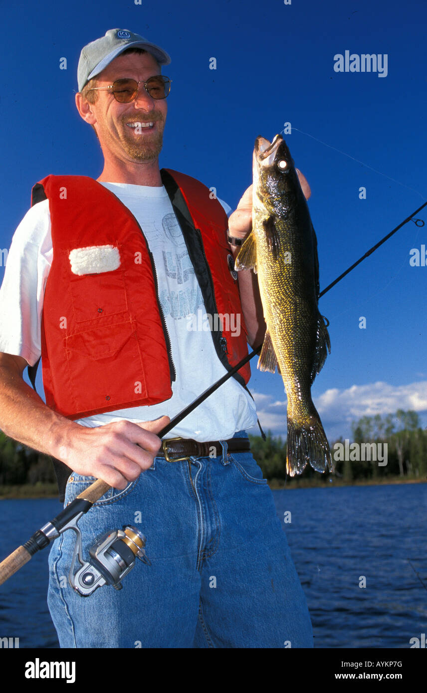 smiling man with walleye and rod Stock Photo - Alamy
