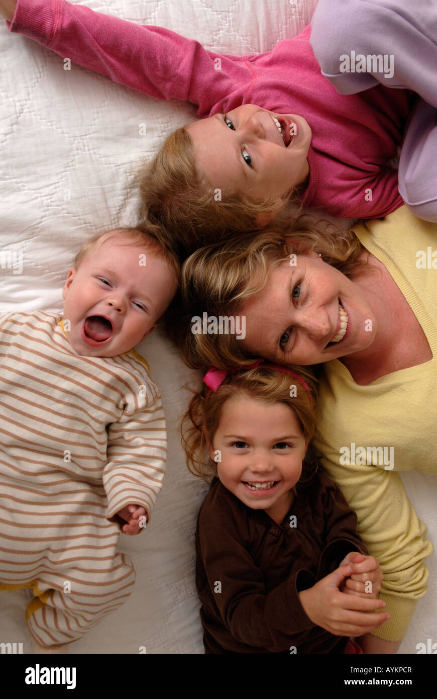 Portrait of a mother and her three children Stock Photo - Alamy