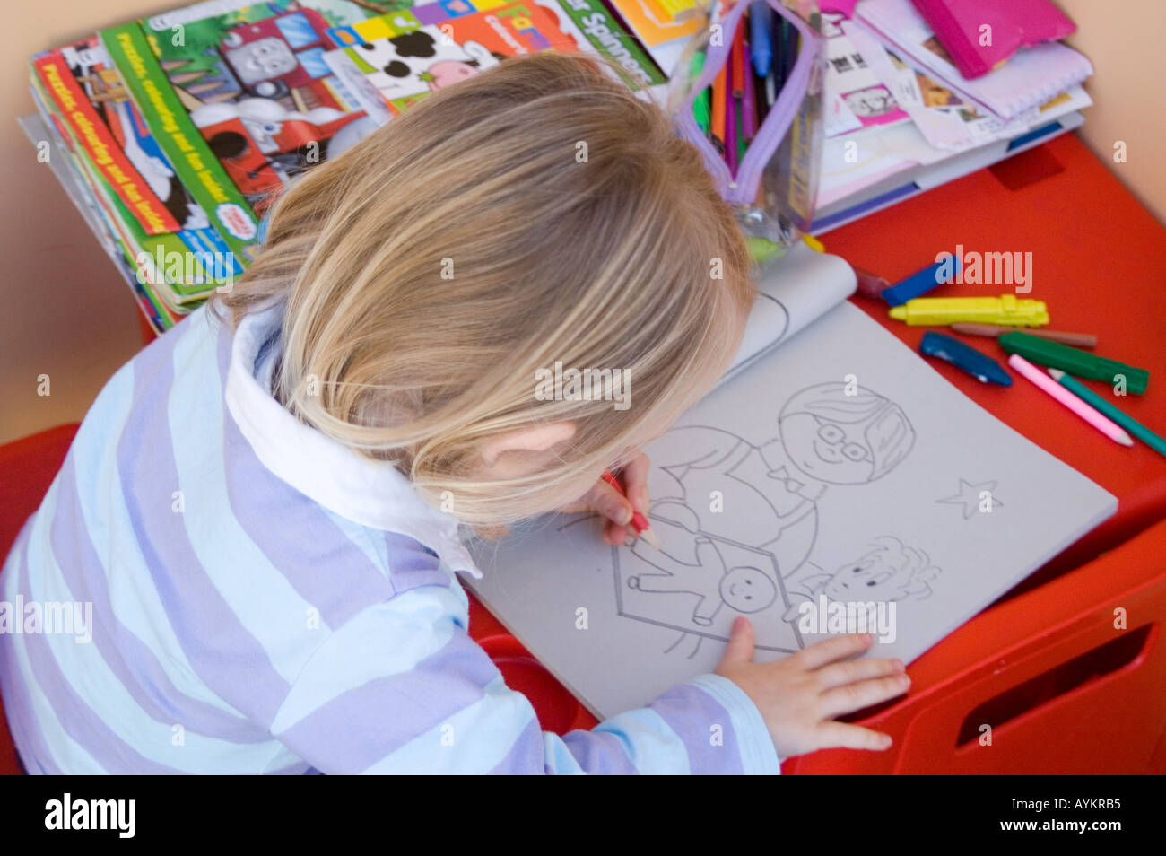 A toddler learning to colour Stock Photo - Alamy
