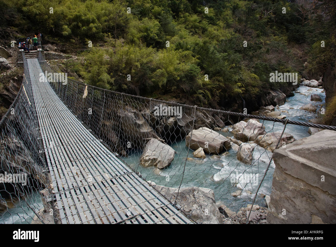 A SUSPENSION FOOT BRIDGE along the NAR PHU RIVER in the ANNAPURNA ...