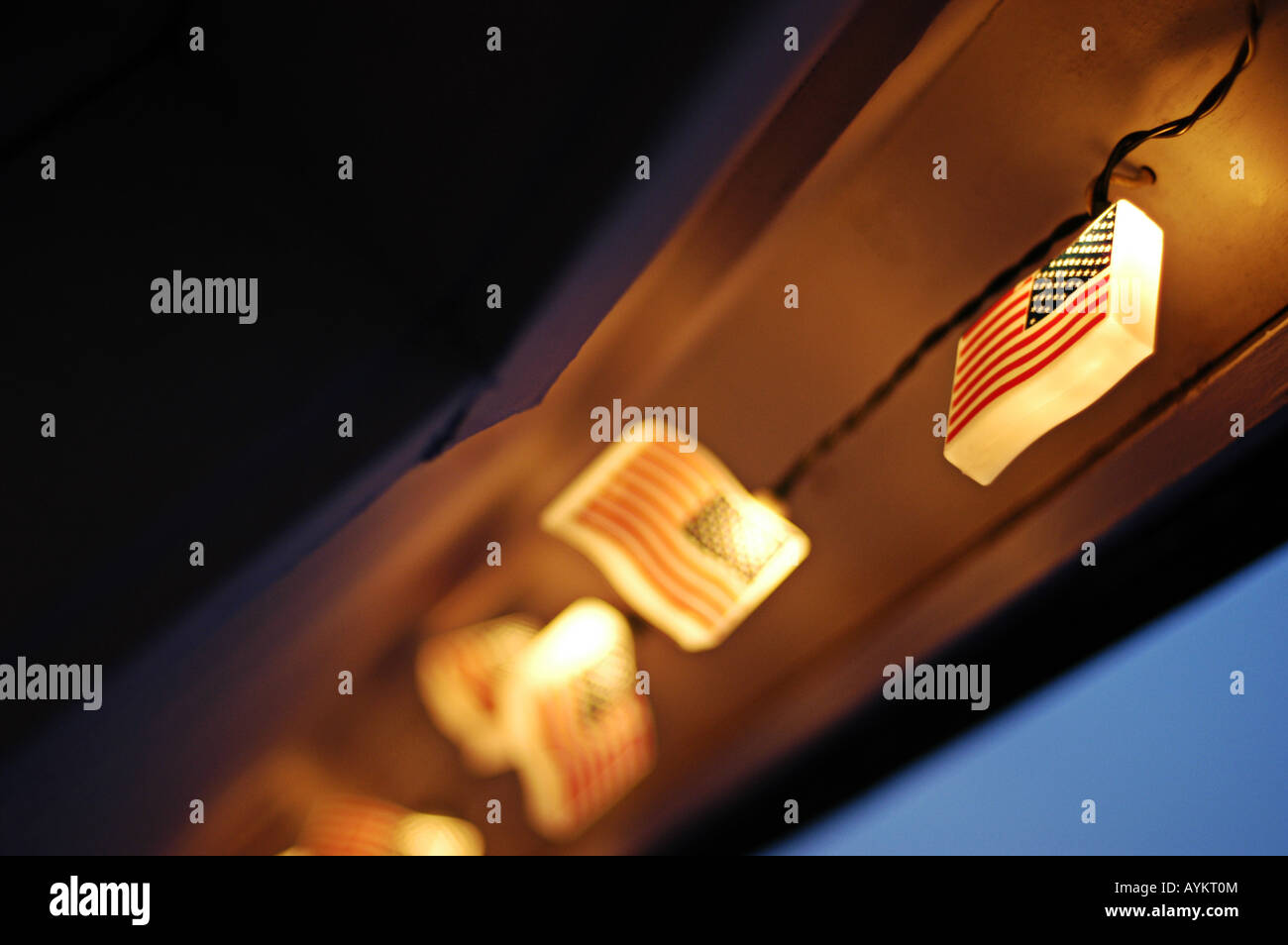 String of lighted U.S. Flags glowing at night Stock Photo - Alamy