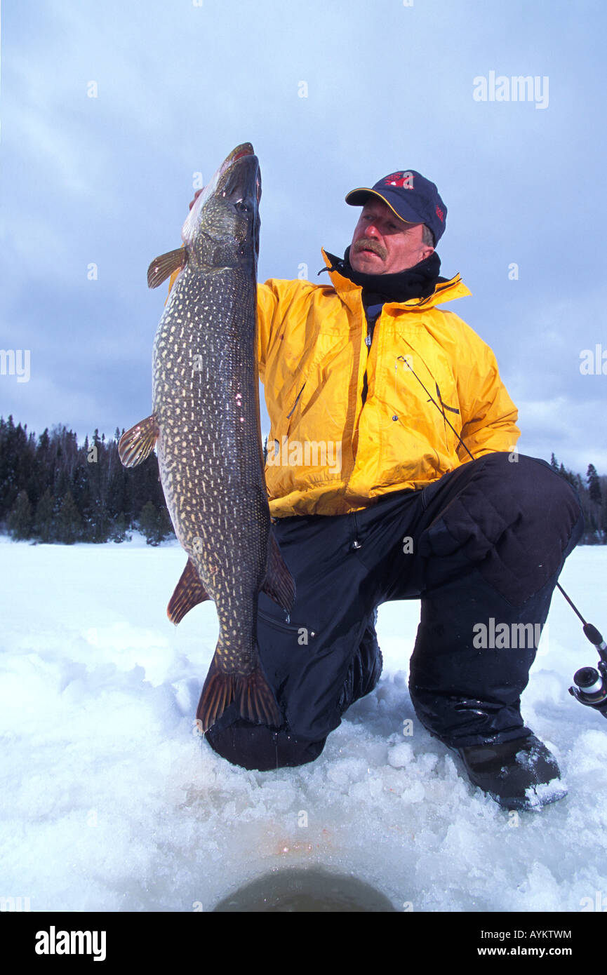 man with big winter pike caught through ice Stock Photo - Alamy