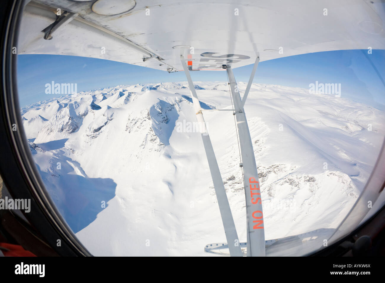 Aerial view from a small Piper plane down to the Scandinavian Mountains ...