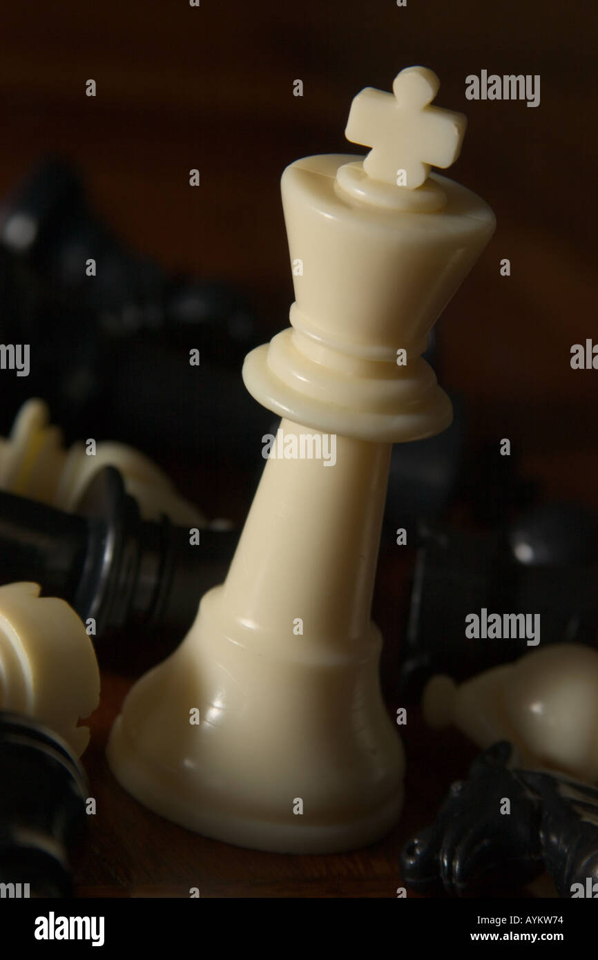 victorious king standing amidst other fallen chess pieces Stock Photo ...