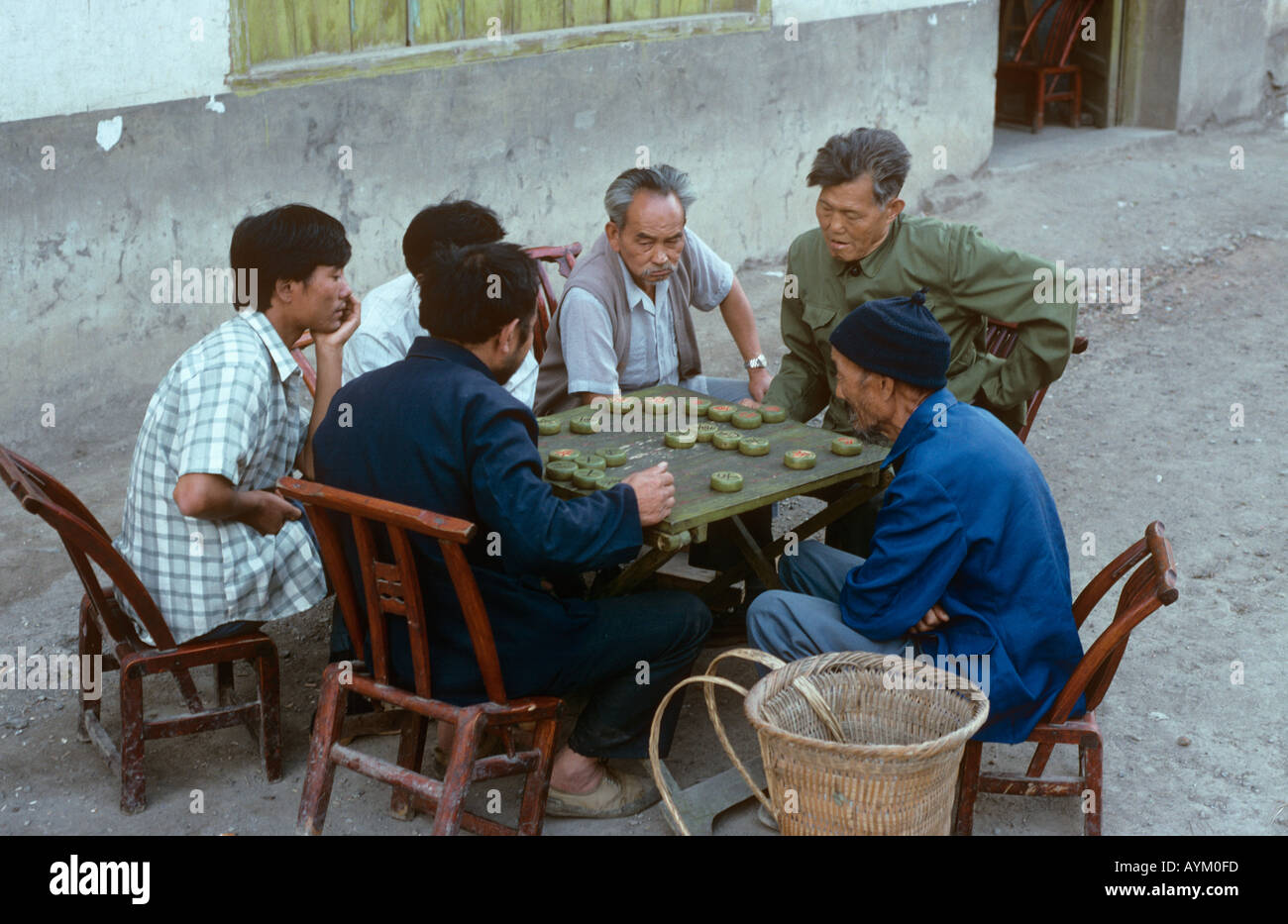 Chinese men playing chequers in the street Xin Long Sichuan Province ...