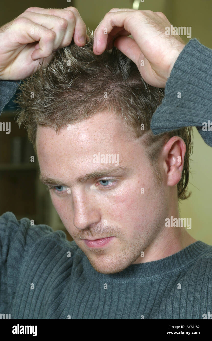 guy stying his hair with gel Stock Photo - Alamy