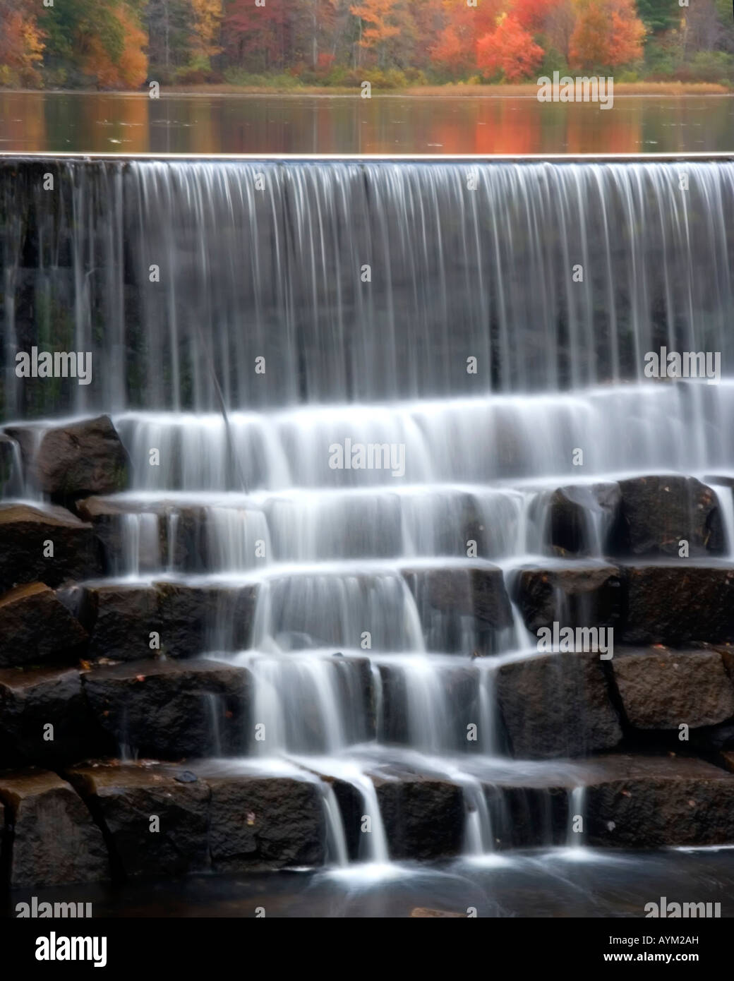 Photograph of waterfall with trees turning into their autumn colors in ...